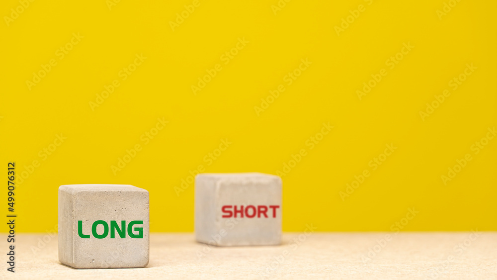 Hand turns a dice and changes the expression SHORT TERM to LONG TERM or ...