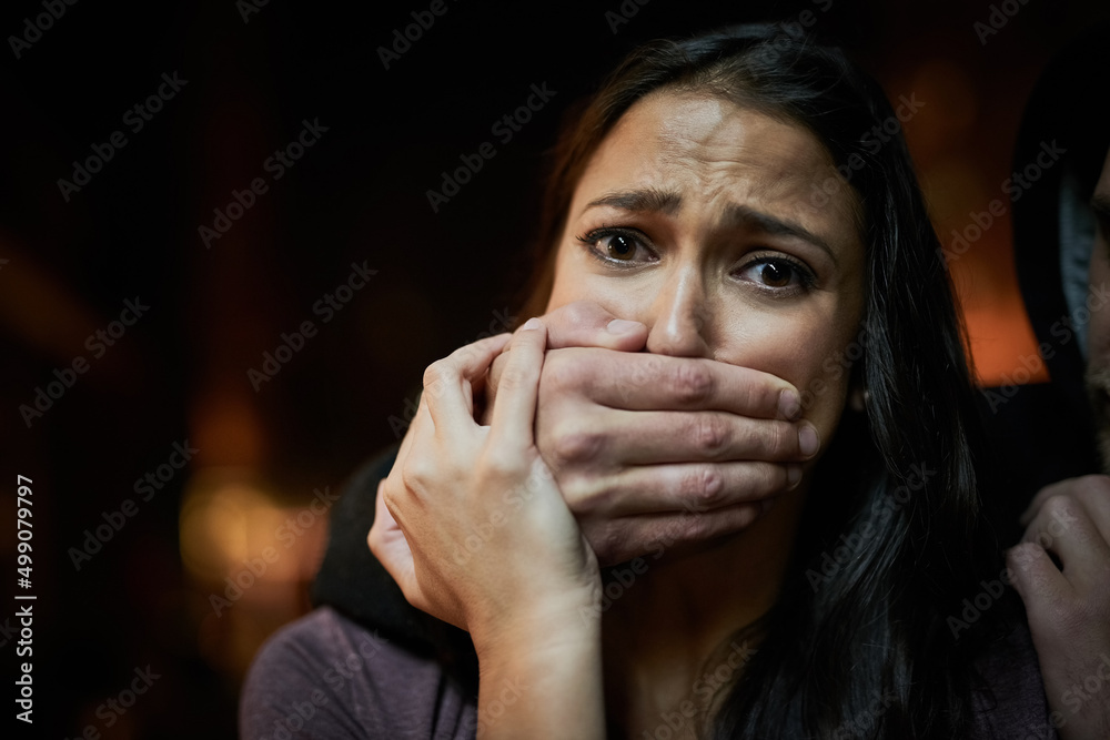 Defenceless and in danger. Portrait of a frightened young woman with ...