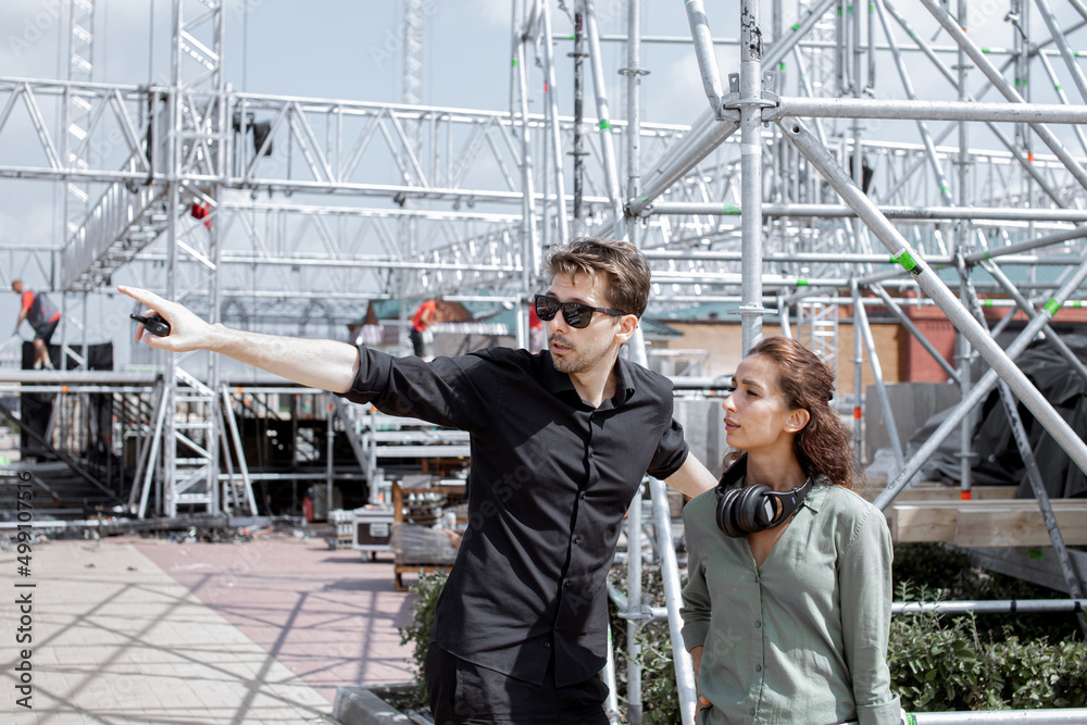 Event managers discuss stage construction. Installation of stage ...