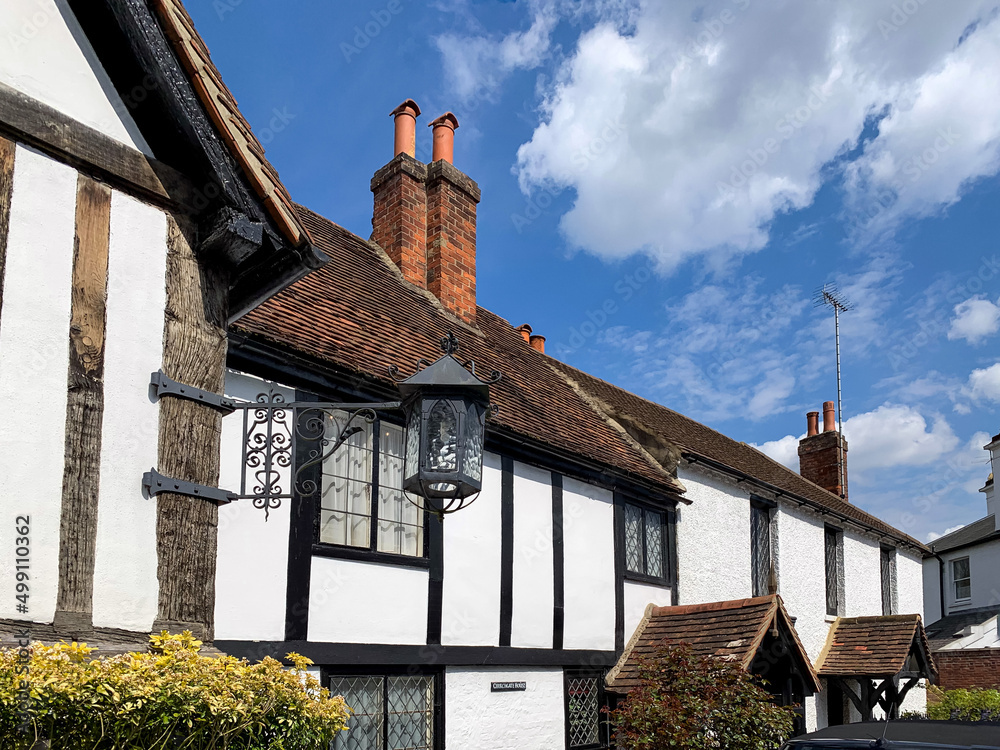 Cookham village, England, Berkshire. Church gate street view. Old half ...