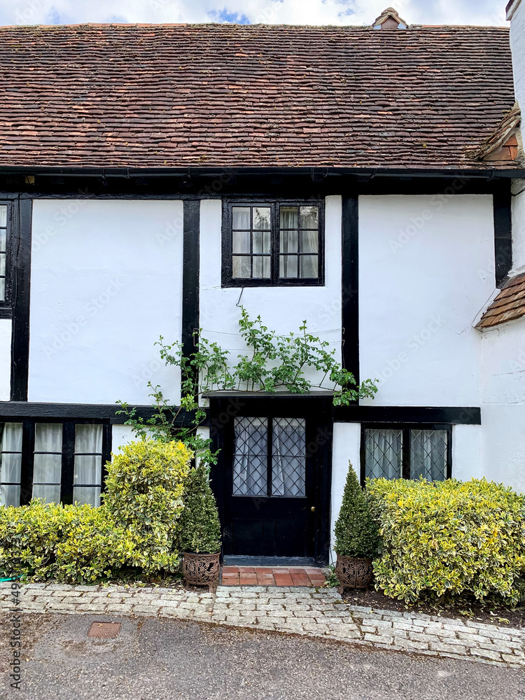 Cookham village, England, Berkshire. Church gate street view. Old half ...