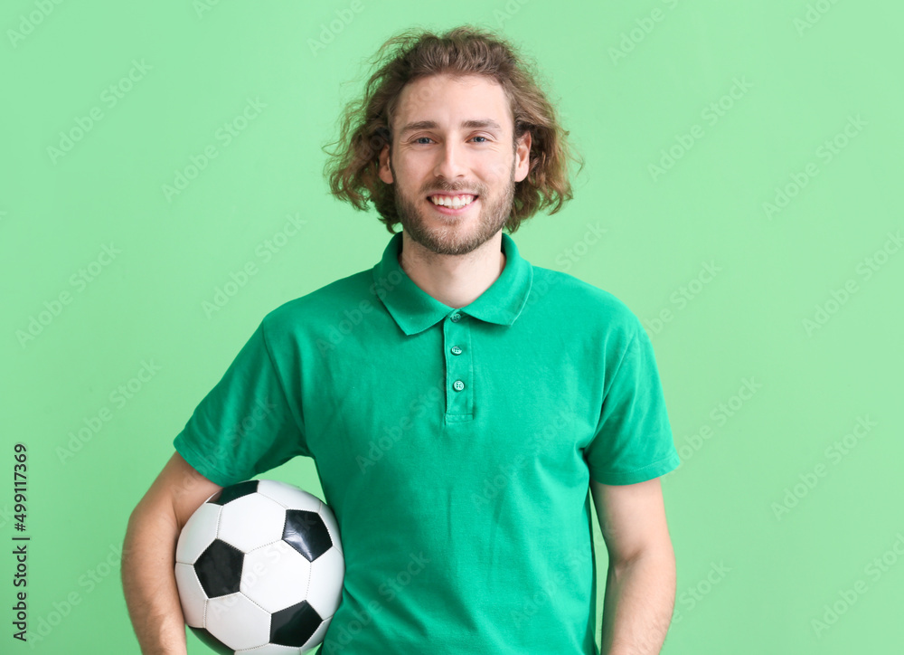 Handsome man in t-shirt with soccer ball on green background Stock ...