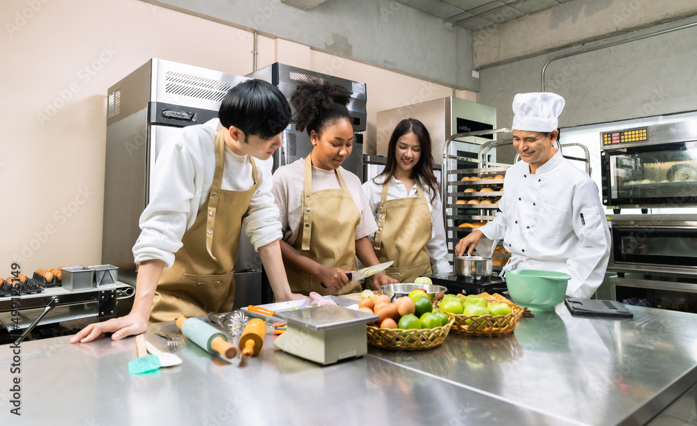 Foto de Cooking course , senior Asian male chef in cook uniform teaches ...