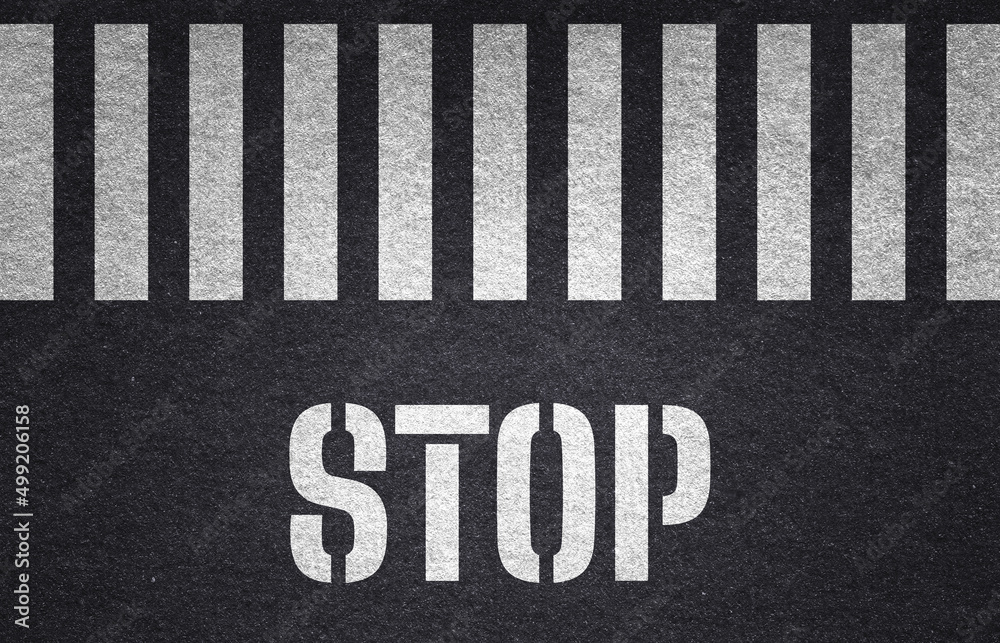 stop sign on the pavement. A blacktop asphalt road with a white line ...