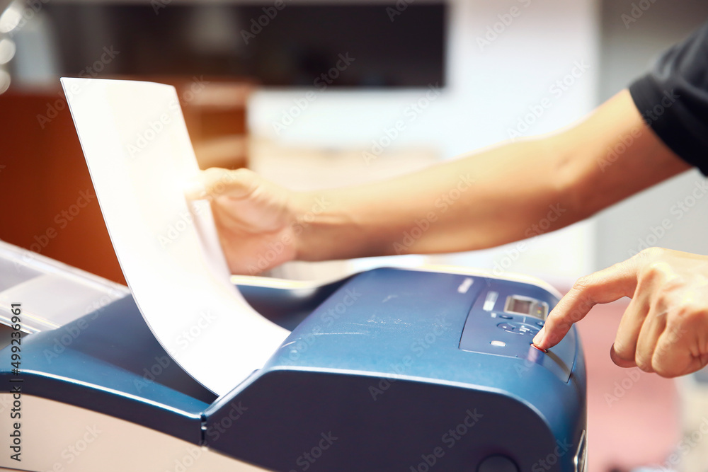 Technician hand press button and load paper in tray to using ...