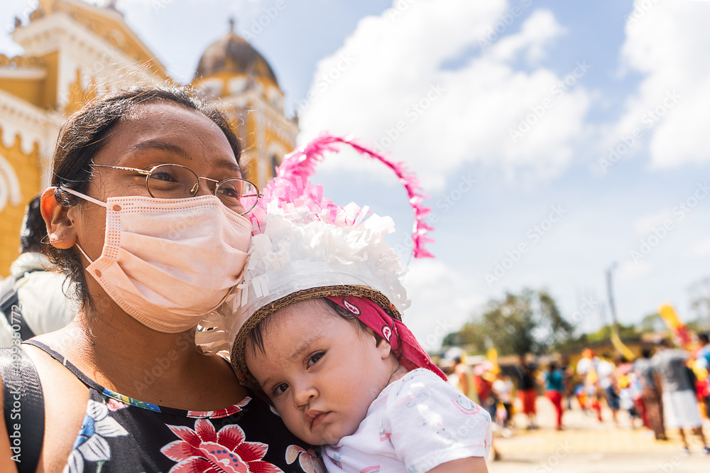 Mother and daughter participating in a holy week religious tradition ...