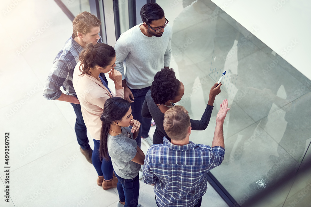 Planning the way forward. High angle shot of a group of people working ...