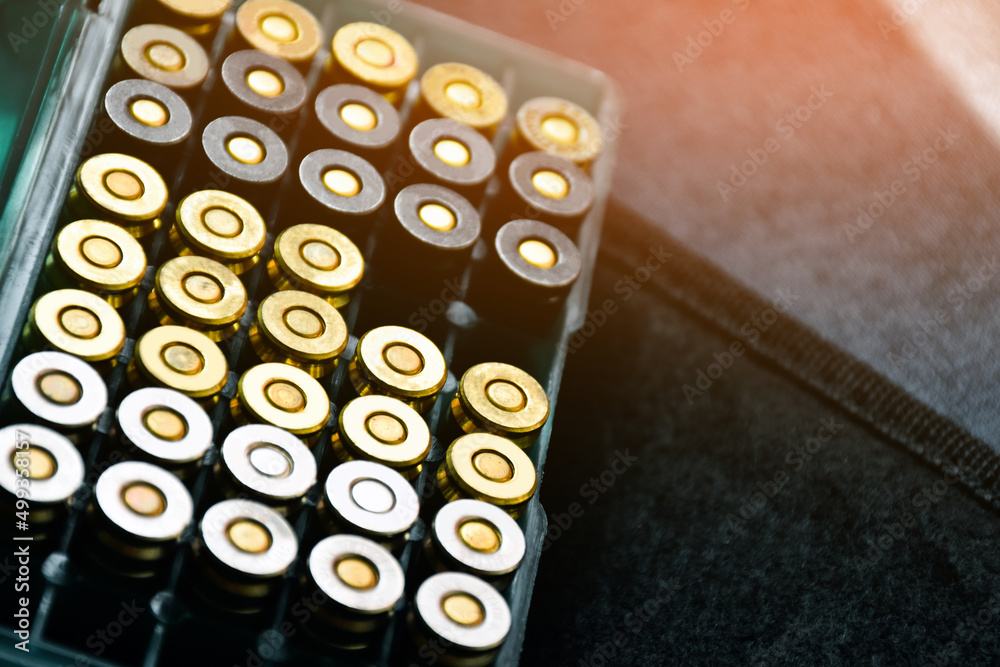 9MM pistol bullets in plastic box on black background, concept for ...