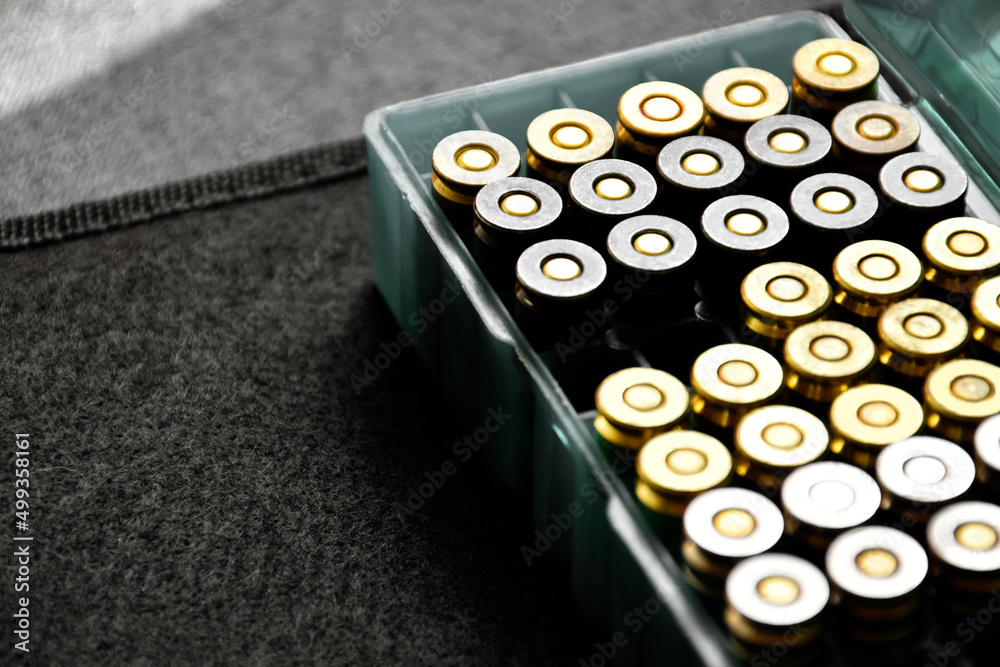 9MM pistol bullets in plastic box on black background, concept for ...