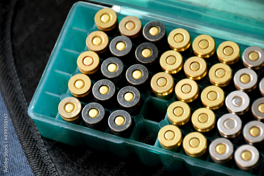 9MM pistol bullets in plastic box on black background, concept for ...