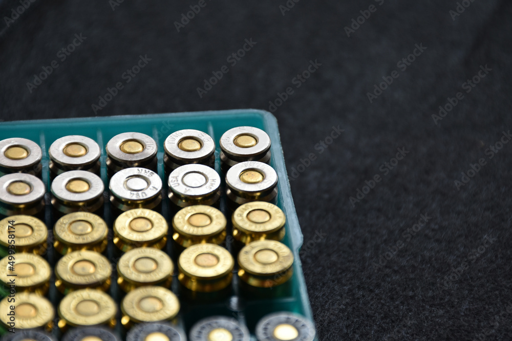 9MM pistol bullets in plastic box on black background, concept for ...