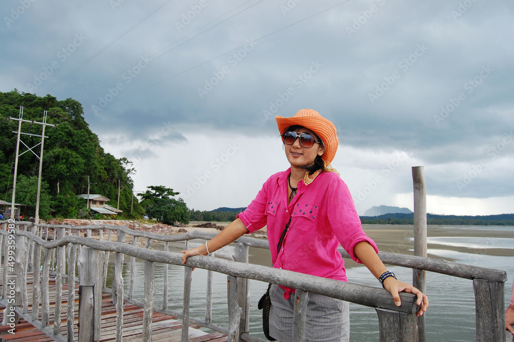 Travelers thai women on wooden bridge pier boat in sea ocean on eastern ...