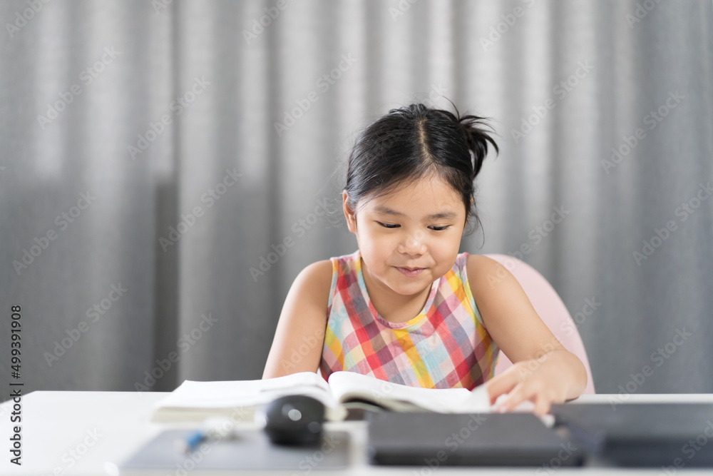 Asian child student or kid girl smile reading on book to learning and ...