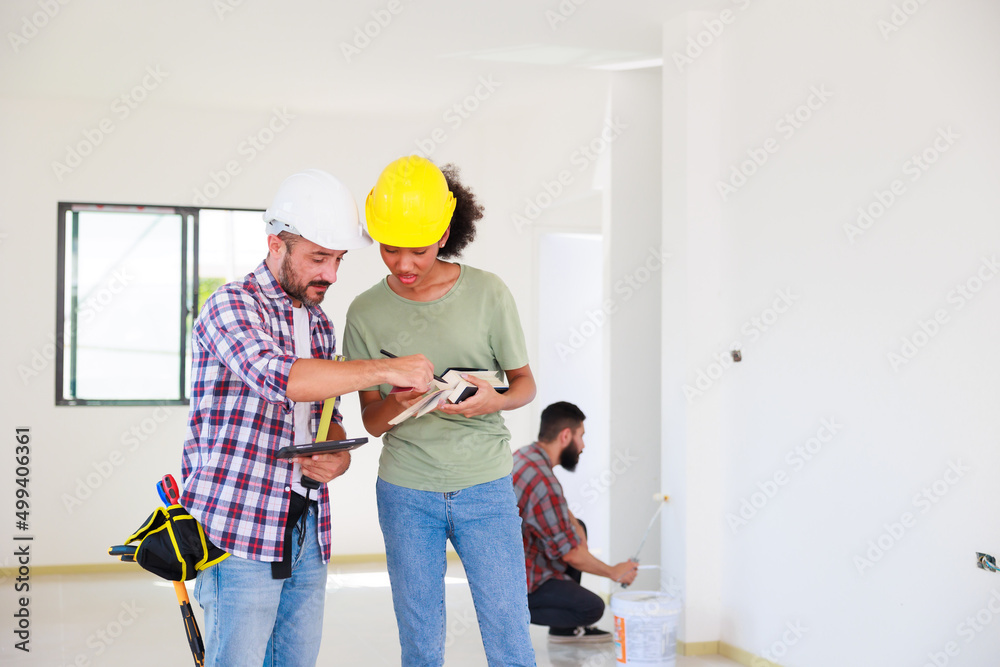 indoors. Painter with roller and color palette. Young african american ...