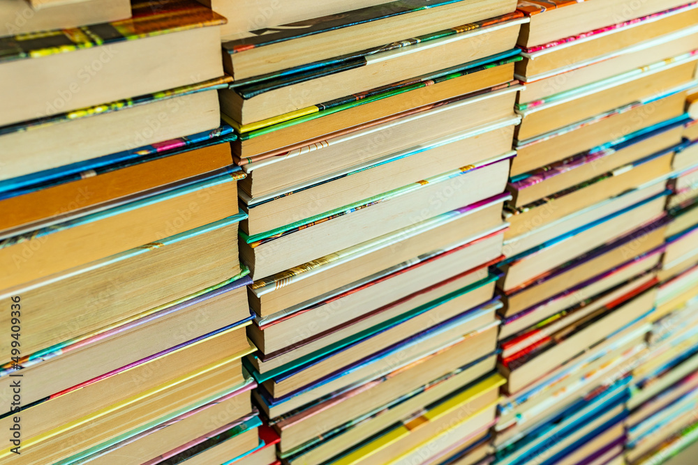 Endless wall of old books stack background. Colorful educational used ...