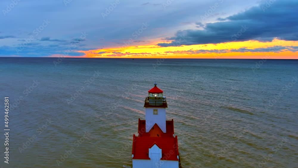 Backward flying drone reveal of lighthouse and long pier at dawn. Stock ...