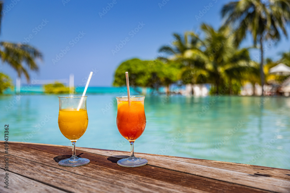 Perfect summer beach resort, poolside with two colorful cocktails ...
