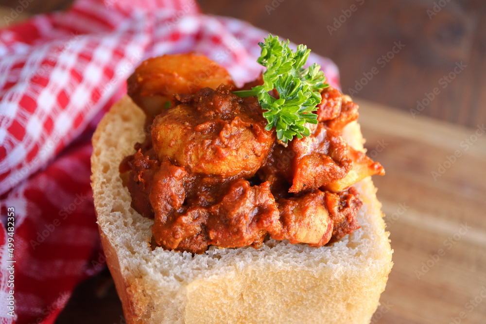 Bunny chow filled with chicken curry. A traditional South African ...