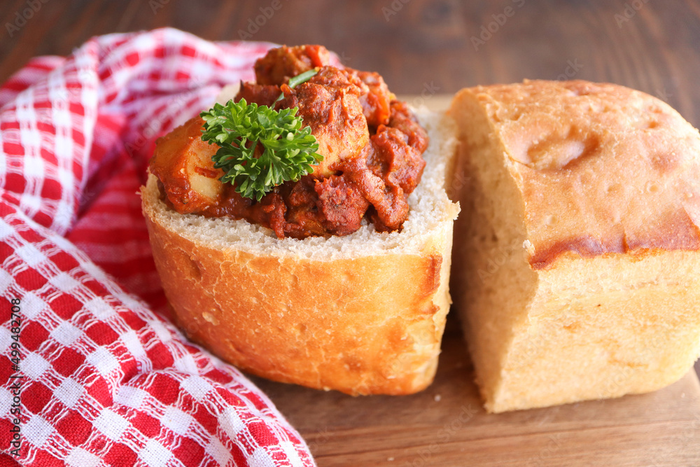 Bunny chow filled with chicken curry. A traditional South African ...
