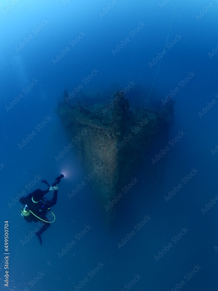 ship wreck underwater deep sea bottom metal on ocean floor scuba divers ...