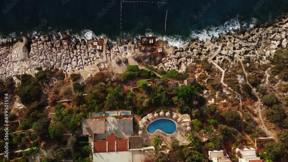 Top view of a coastal resort with lounge zone and swimming pool located ...