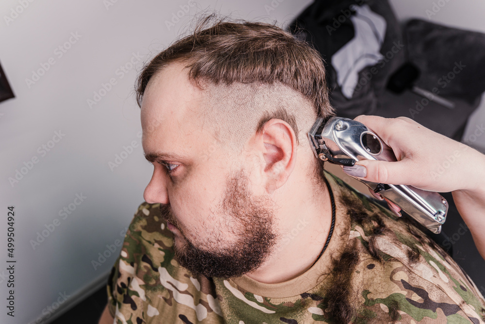 young man in a military uniform shaves his head bald for military ...