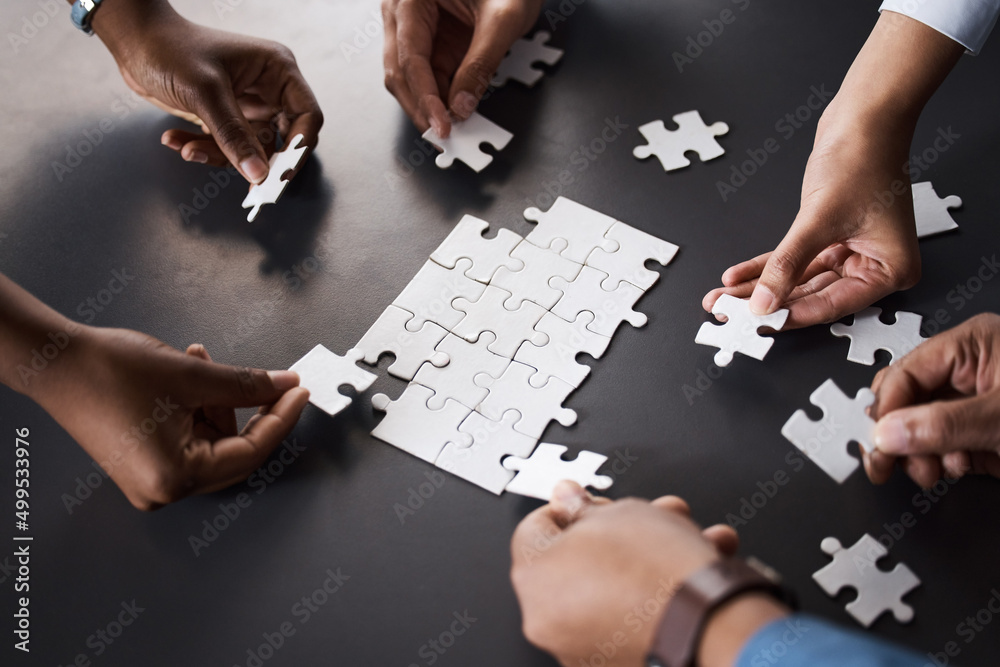 Problem solving as a dedicated team should. Closeup shot of a group of ...