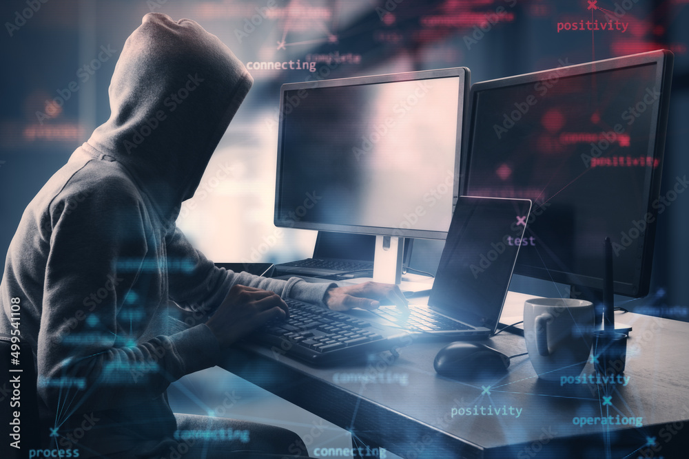 Side view of hacker at desktop using computers with creative process ...