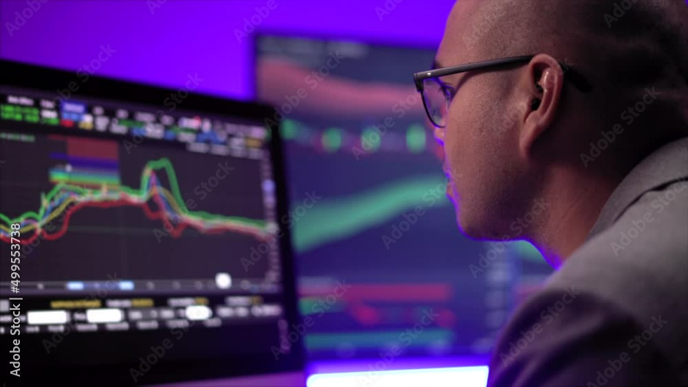 Financial analyst working with exchange rate diagram in neon light ...