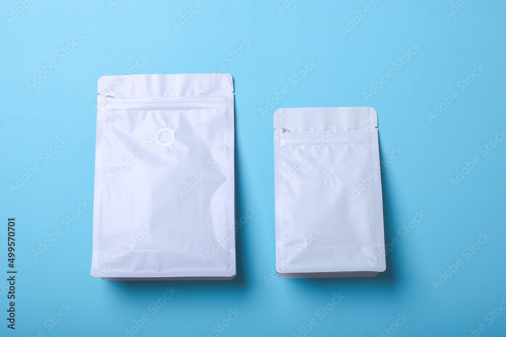 White standing pouch bag with zip lock and valve on blue background ...