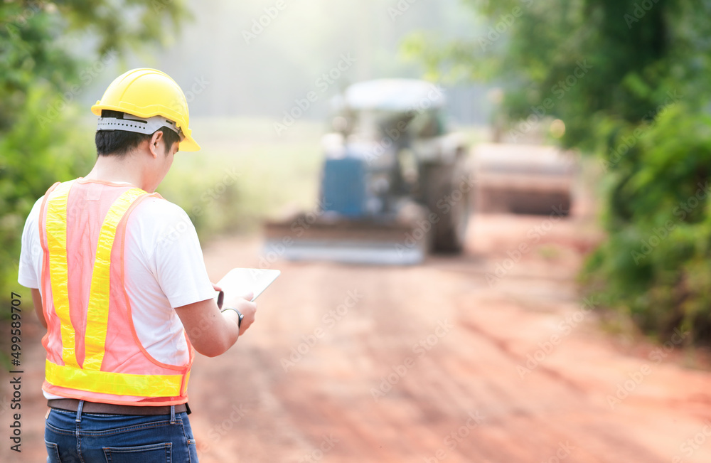 Civil engineers in reflective vests, helmets, check plans and plans in ...