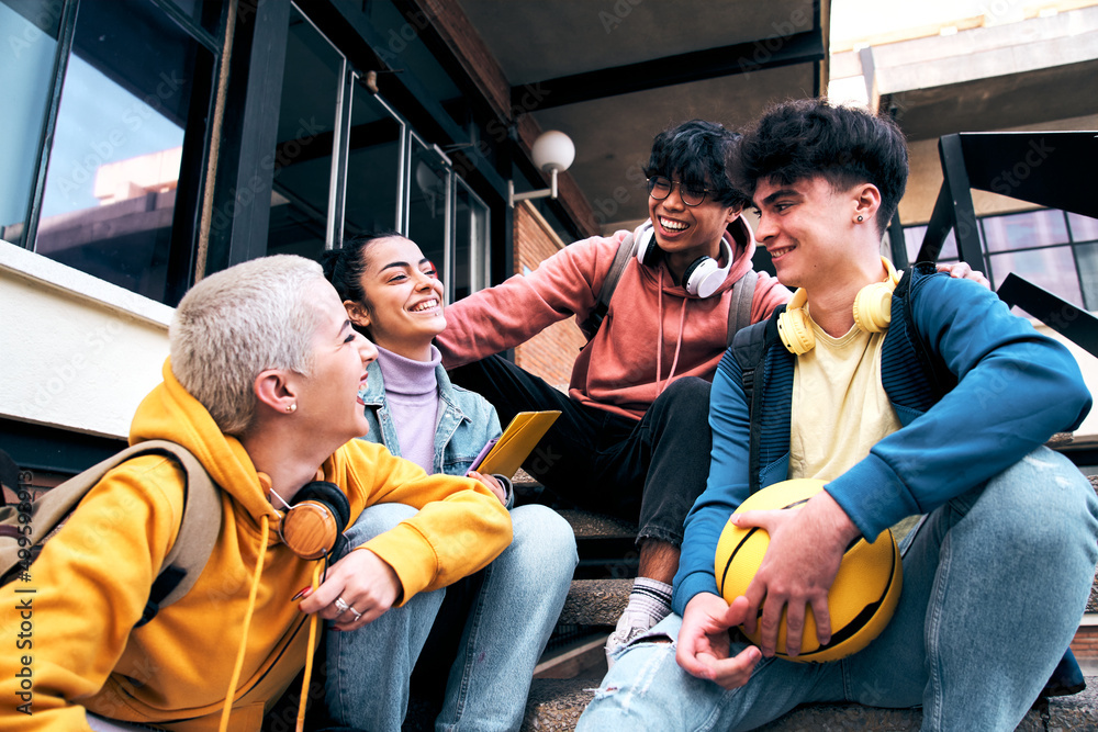 Group of young happy people talking and having fun together outdoors at ...