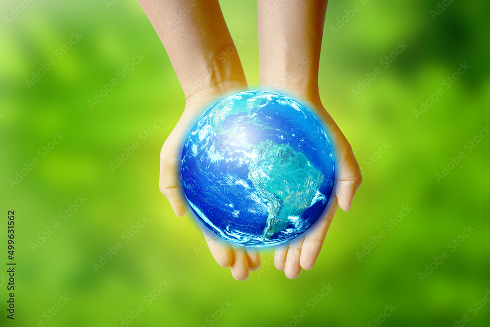 Human Hands holding Earth ball on green bokey natural background ...