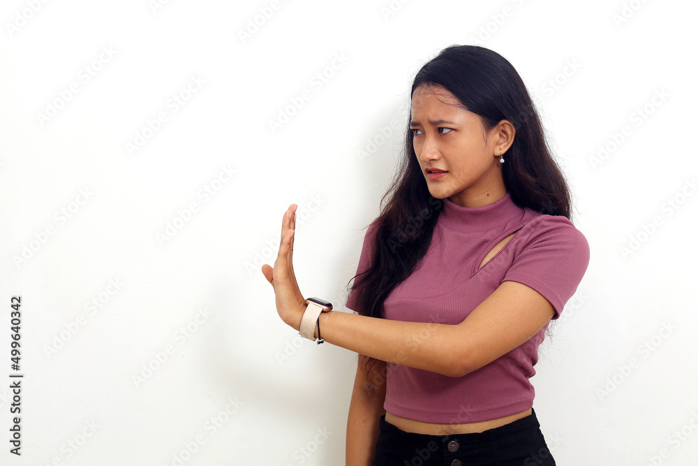 Asian girl showing five finger stop posture and looking straight beside ...