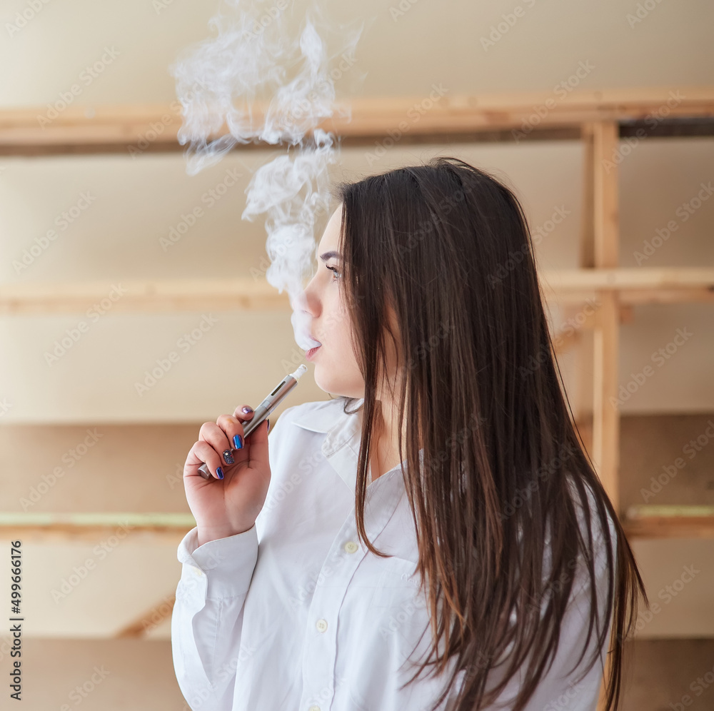 Modern girl smoking vape.Trendy new vaping device,smoke e-liquid ...