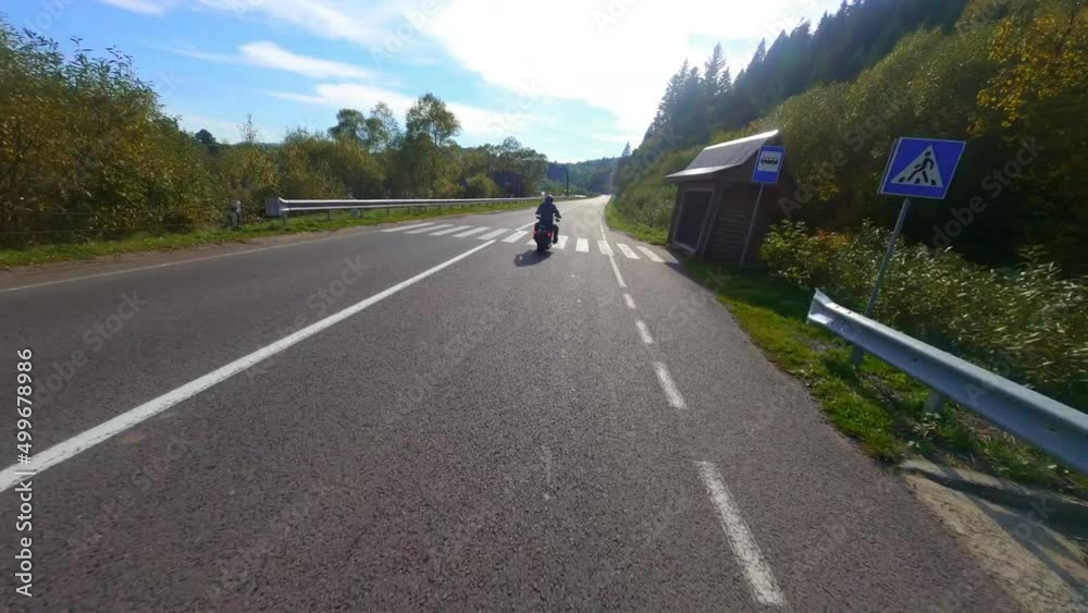 Motion view of professional extreme biker traveling alone riding bike ...