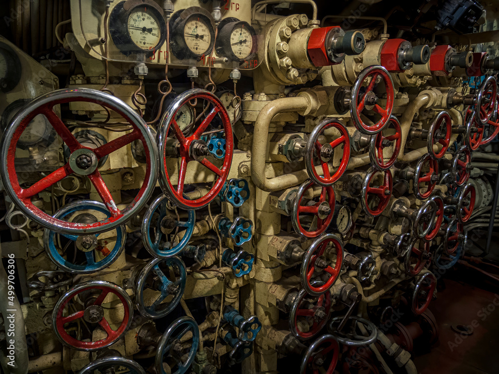 Circular pressure valves and gauges in control room inside submarine ...