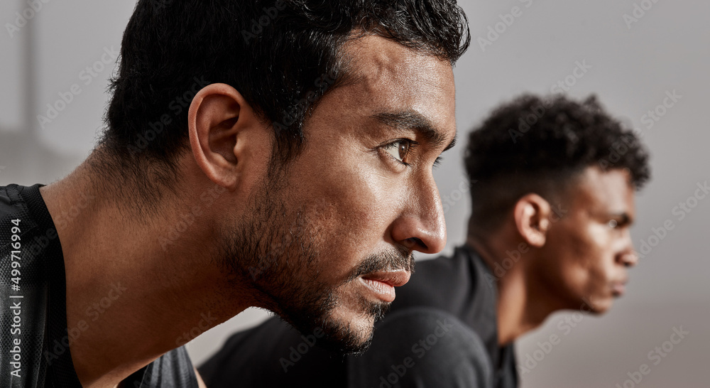 Im coming for that medal. Shot of two male athletes competing in a race ...