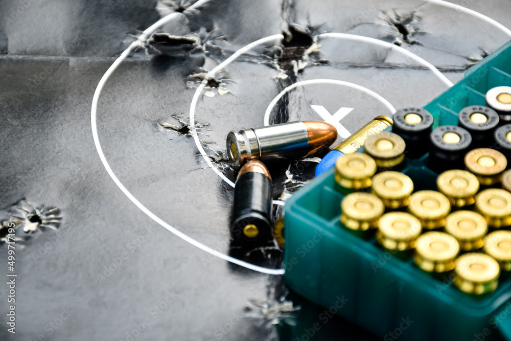 9mm bullets on man-target shooting paper and in the plastic box ...