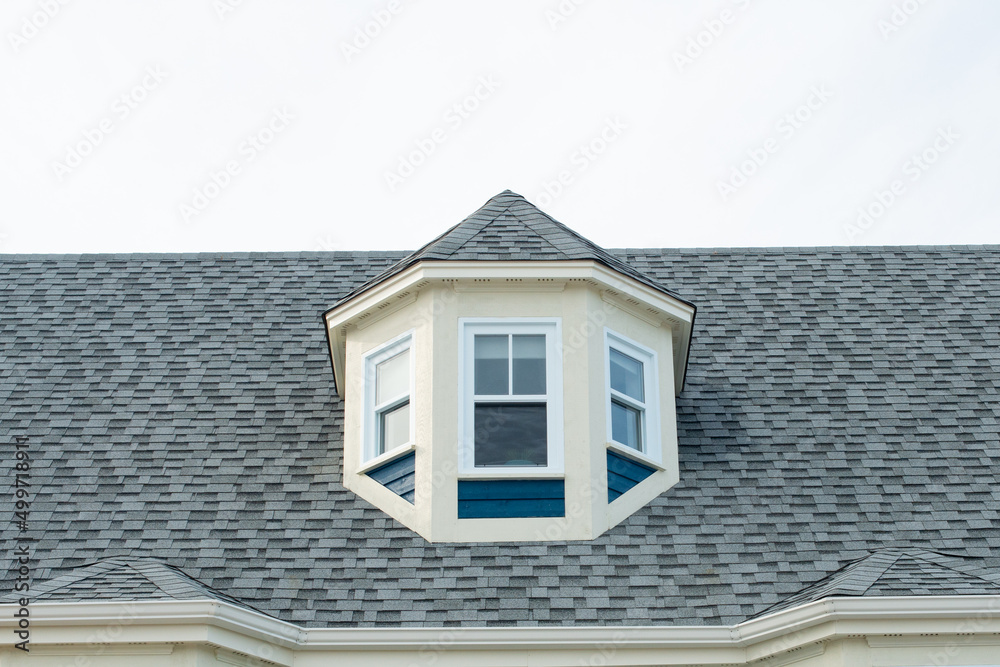 A Pyramidal Roof Dormer With Three Small Closed Glass Windows Outward
