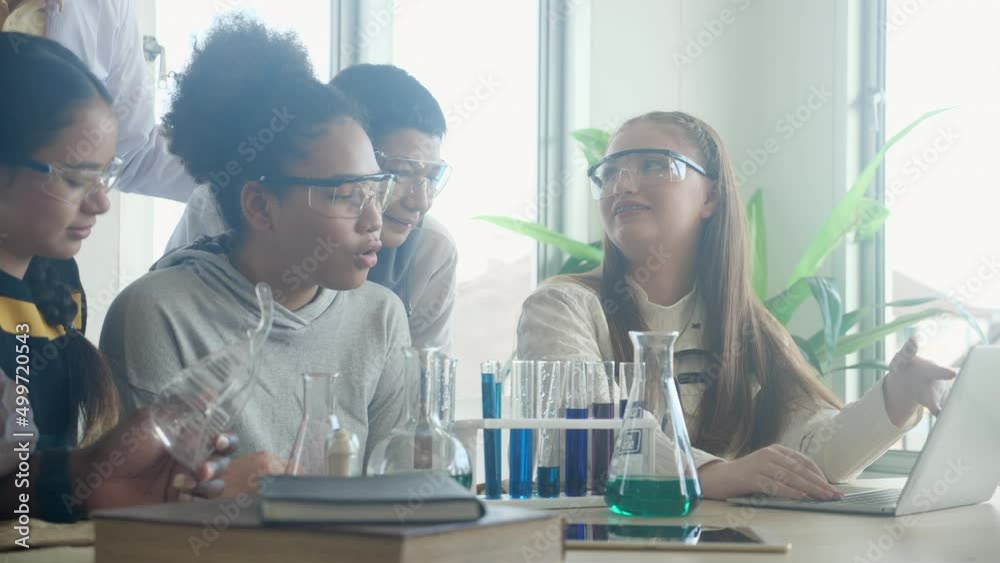 Young teacher teaching group student about science and explaining ...