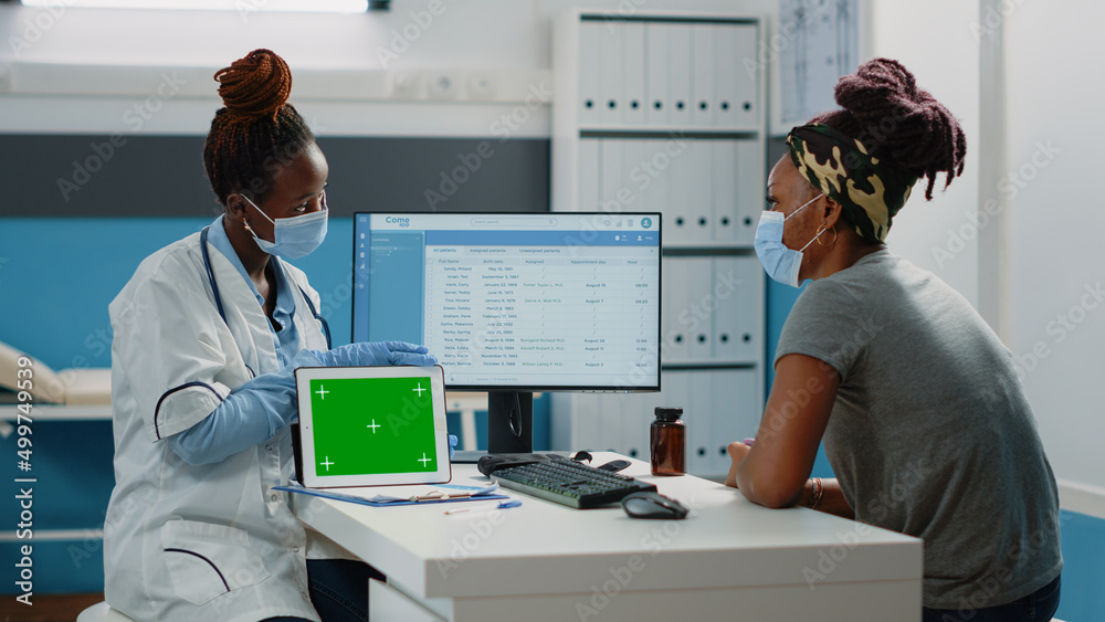 Medic holding horizontal green screen on modern tablet. Doctor showing ...