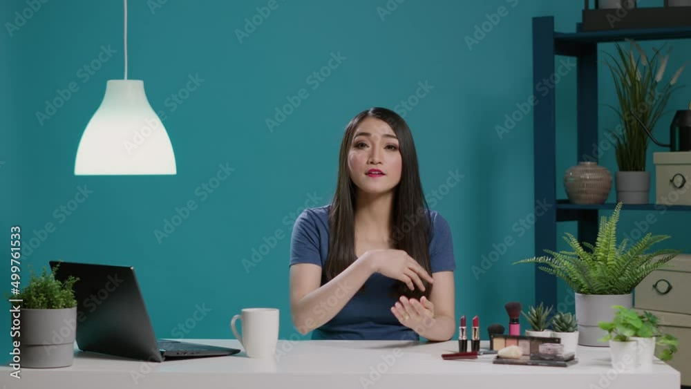 Content creator recording beauty vlog with cosmetics in studio, filming ...