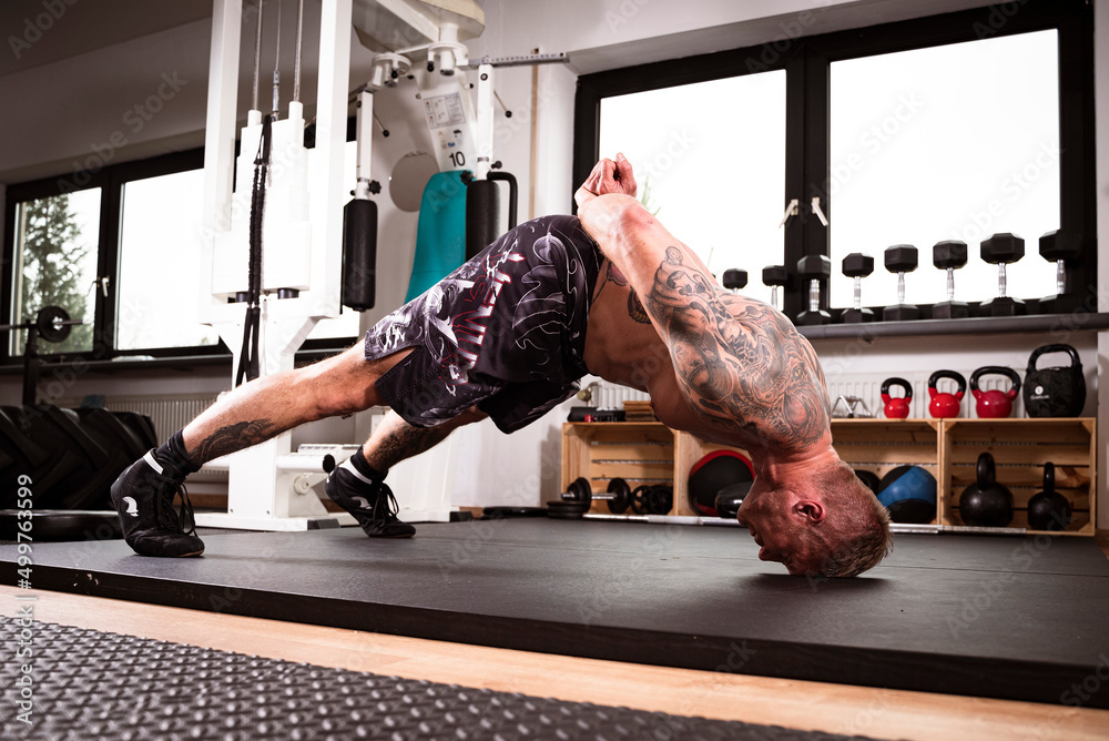 athlete trains his body on the ground. fighter trains muscles Stock ...