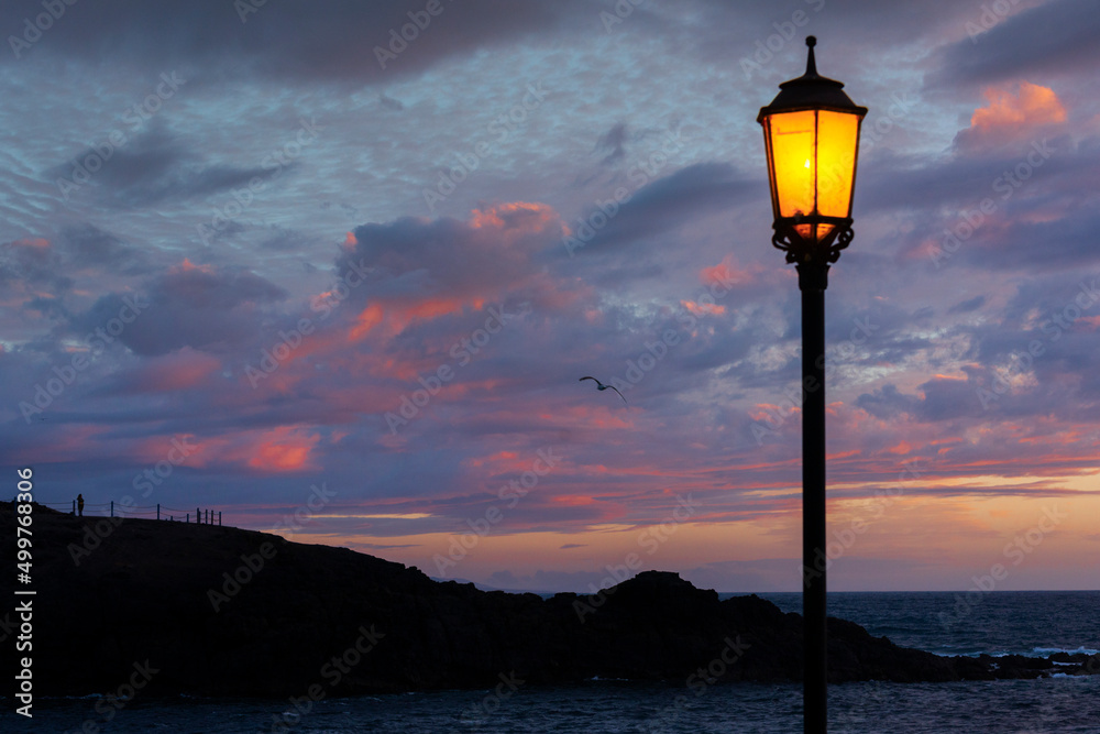 Illuminated Lamp post by beach at sunset, El Cotillo, Fuerteventura ...