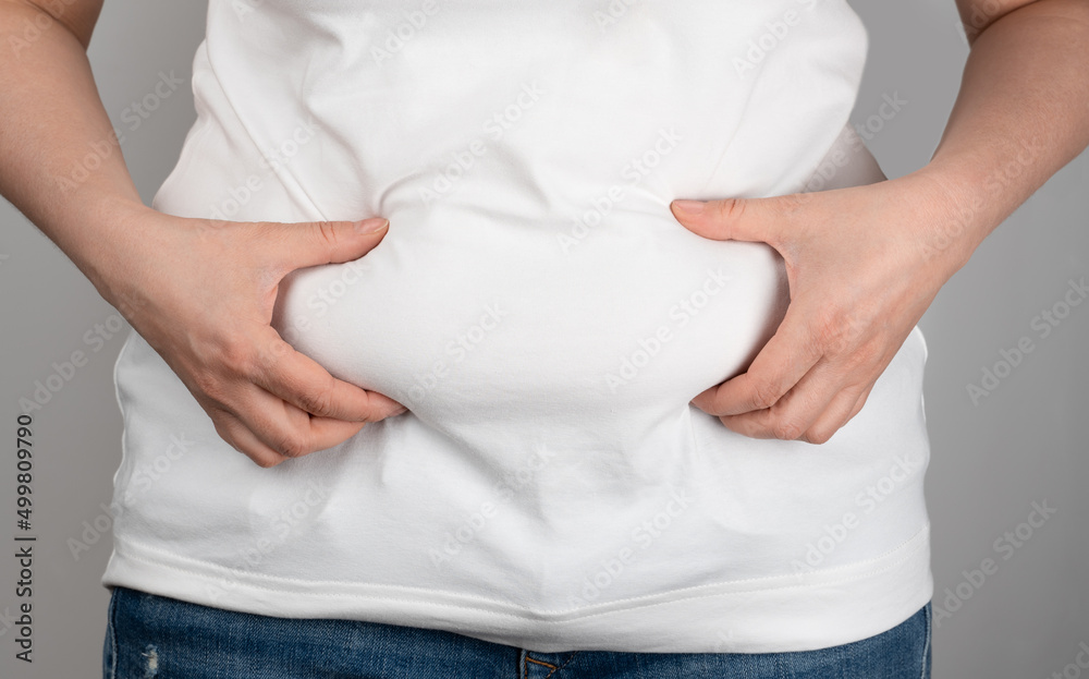 Woman with fat flabby belly, overweight female body on gray background ...
