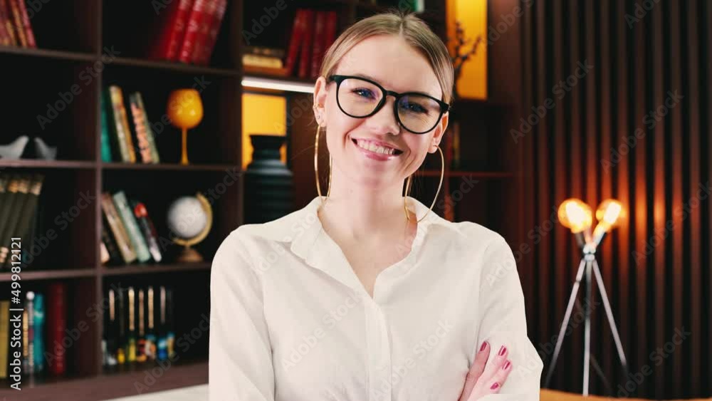 4k Beautiful young smiling woman in white shirt and glasses. Library ...
