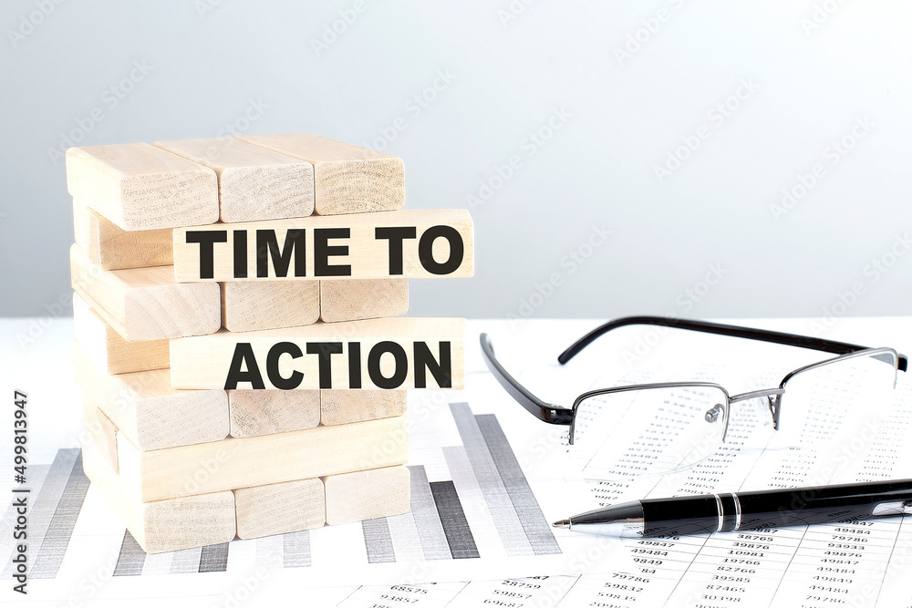 TIME TO ACTION is written on wooden blocks on a chart background Stock ...