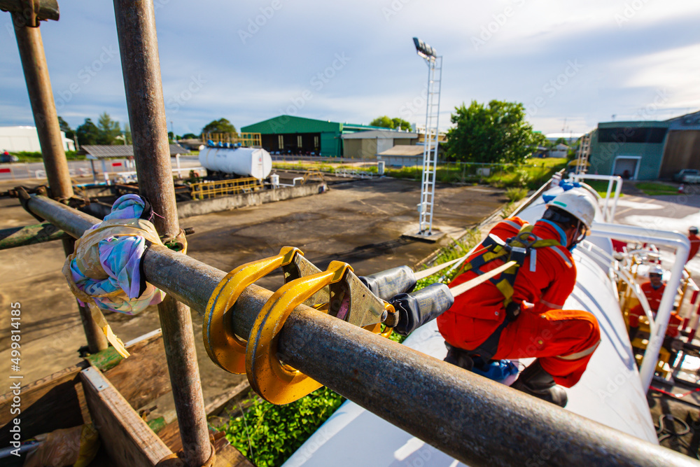 Male worker wearing safety first harness and safety lone working at ...