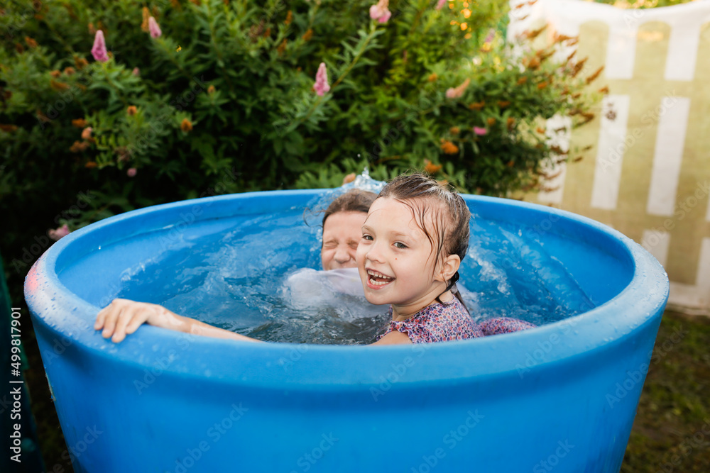 Hot summer and happy childhood. Children splash in a barrel Cheerful ...